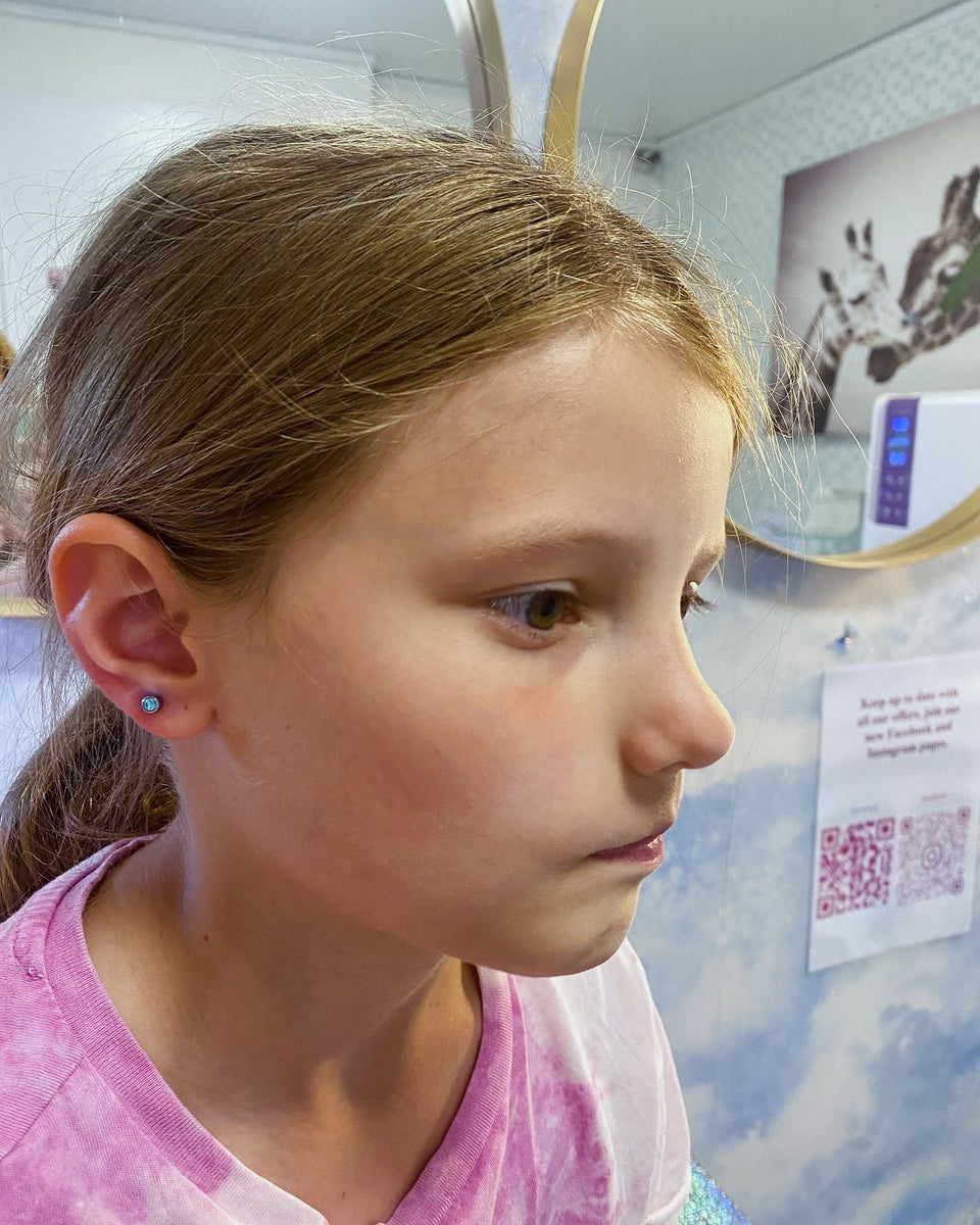 Ear lobes with needle – Bodylink piercing studio Maidstone.